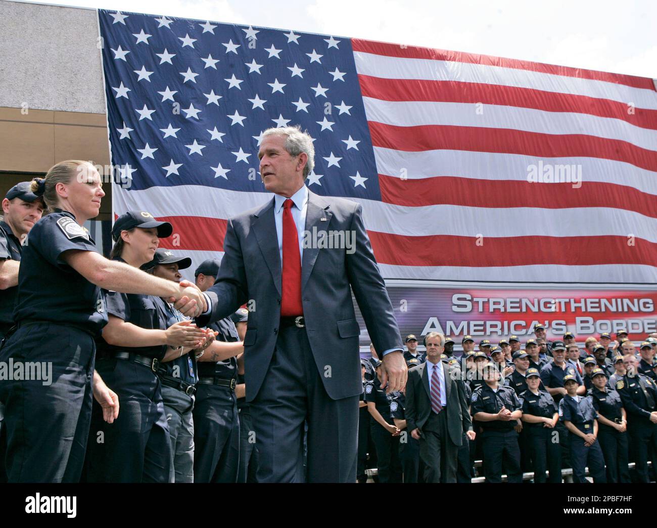 President Bush shakes hands with Customs and Border Patrol trainees ...