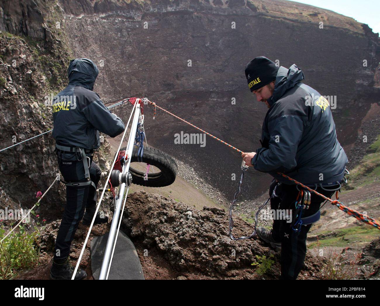Italian forest rangers pull tyres out of from a crater in the Mount ...