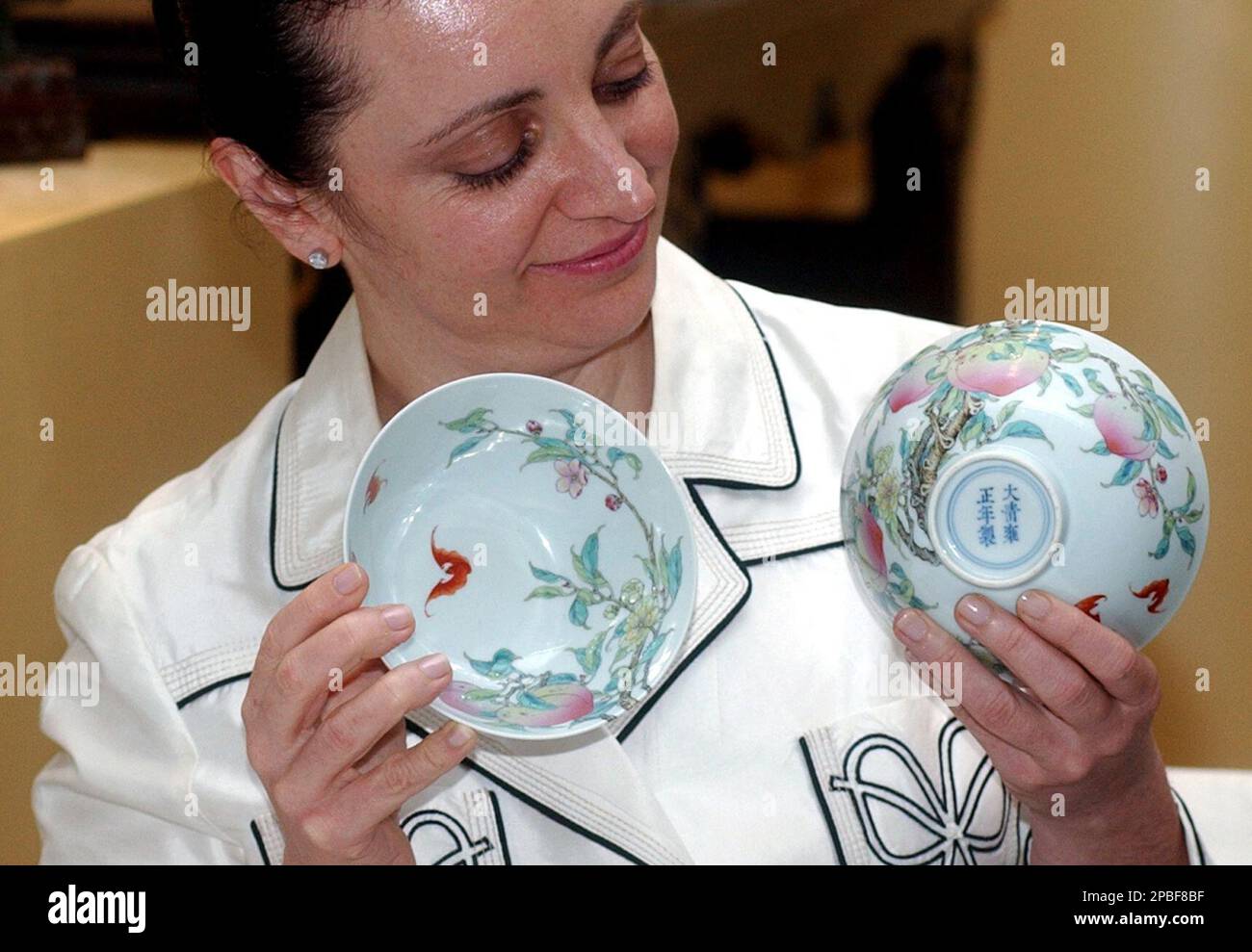 Christie's Senior Vice President Pola Antebi displays two Chinese Qing ...