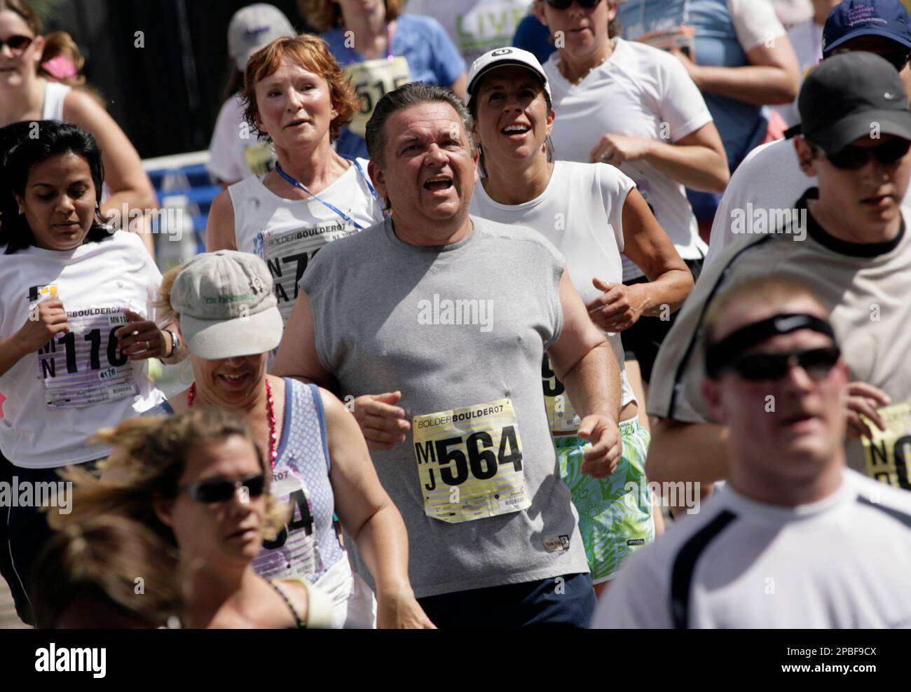 Runners struggle to cross the finish line in Folsom Field to complete ...