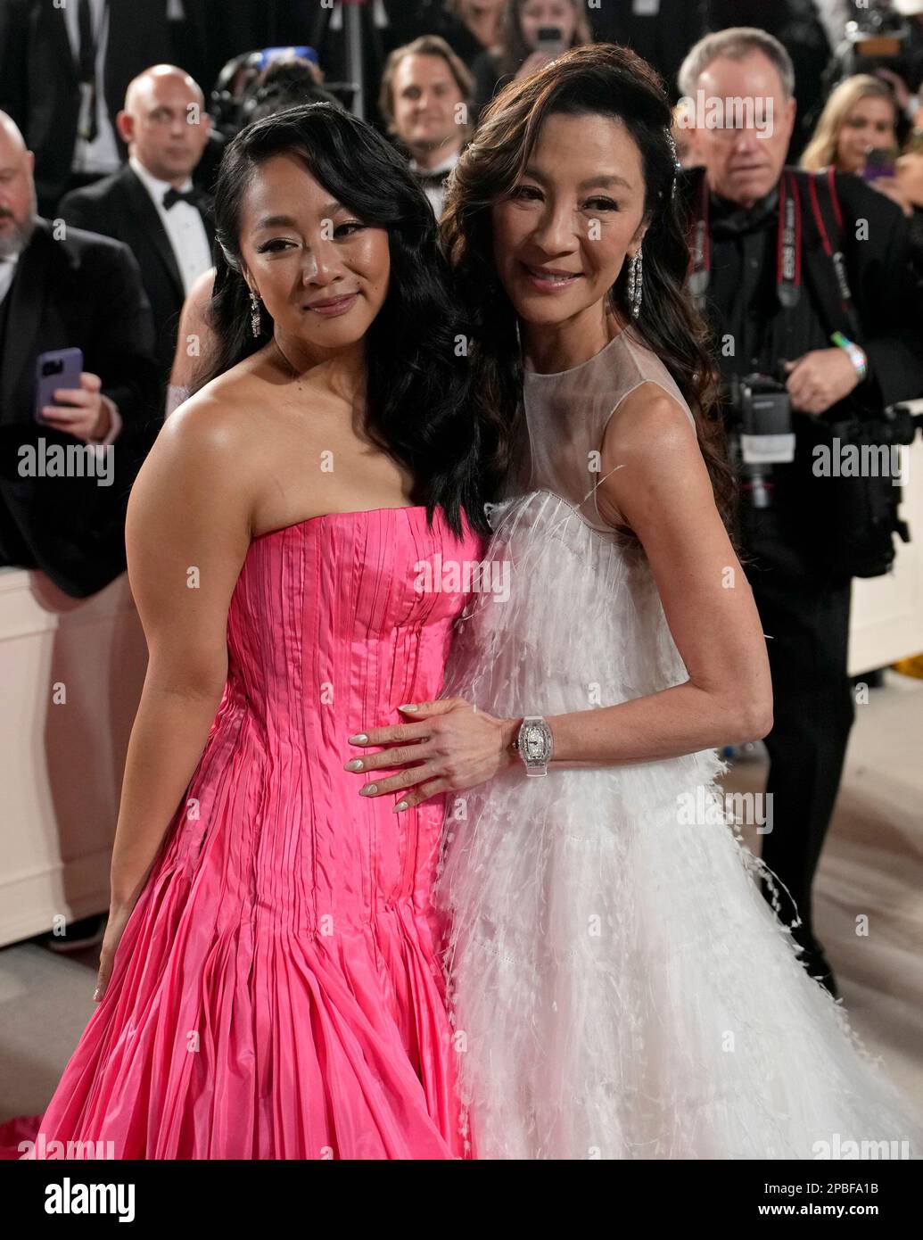 Stephanie Hsu, left, and Michelle Yeoh arrive at the Oscars on Sunday ...