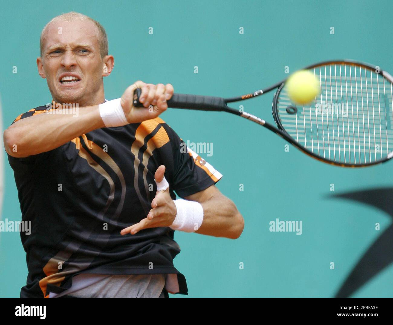 Russia's Nikolay Davydenko returns the ball to Italy's Stefano Galvani ...