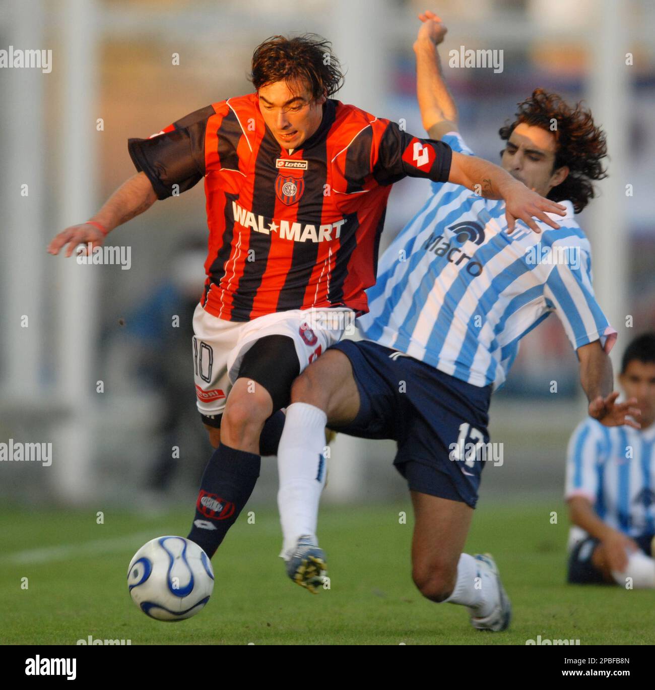 San Lorenzo's Ezequiel Lavezzi, left, battles for the ball with ...