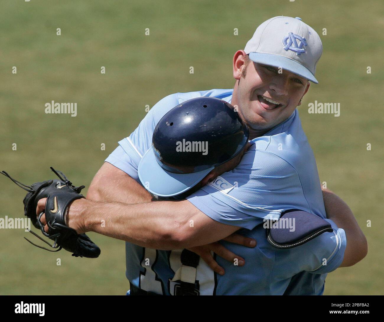 North Carolina relief pitcher Andrew Carignan, top, hugs his catcher ...