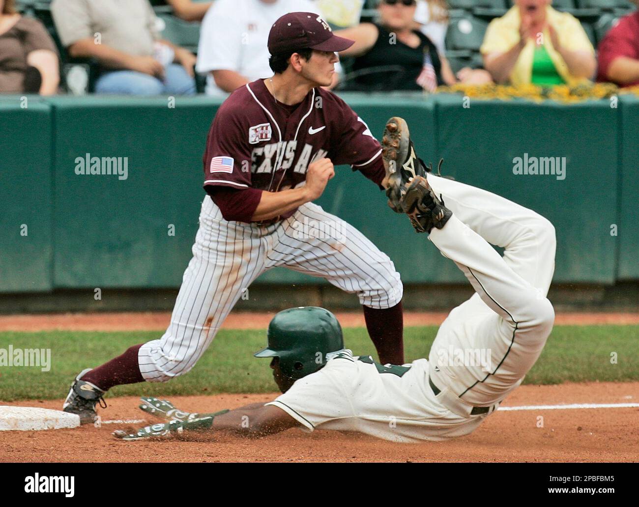Baylor's Paul Miles, front, slides safely into third base with a two ...