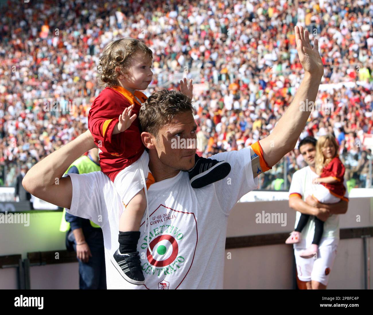 AS Roma's Francesco Totti and his son Cristian wave supporters at the ...