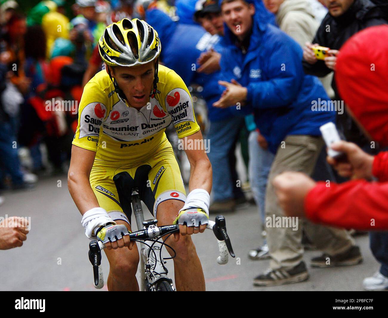 Supporters cheer Italy's Riccardo Ricco' as he pedals to win the 15th ...