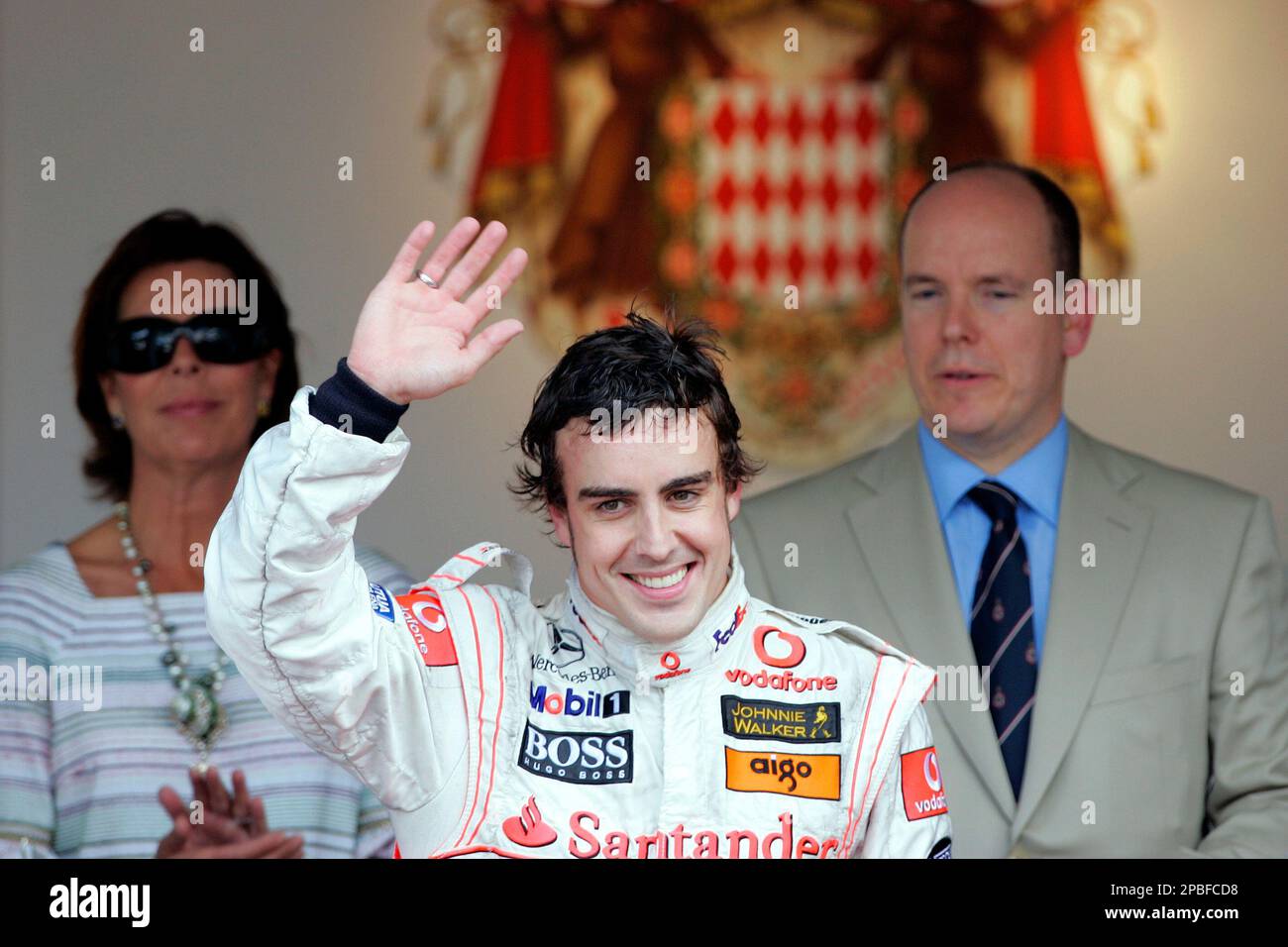 McLaren Mercedes driver Fernando Alonso of Spain, center, waves from ...