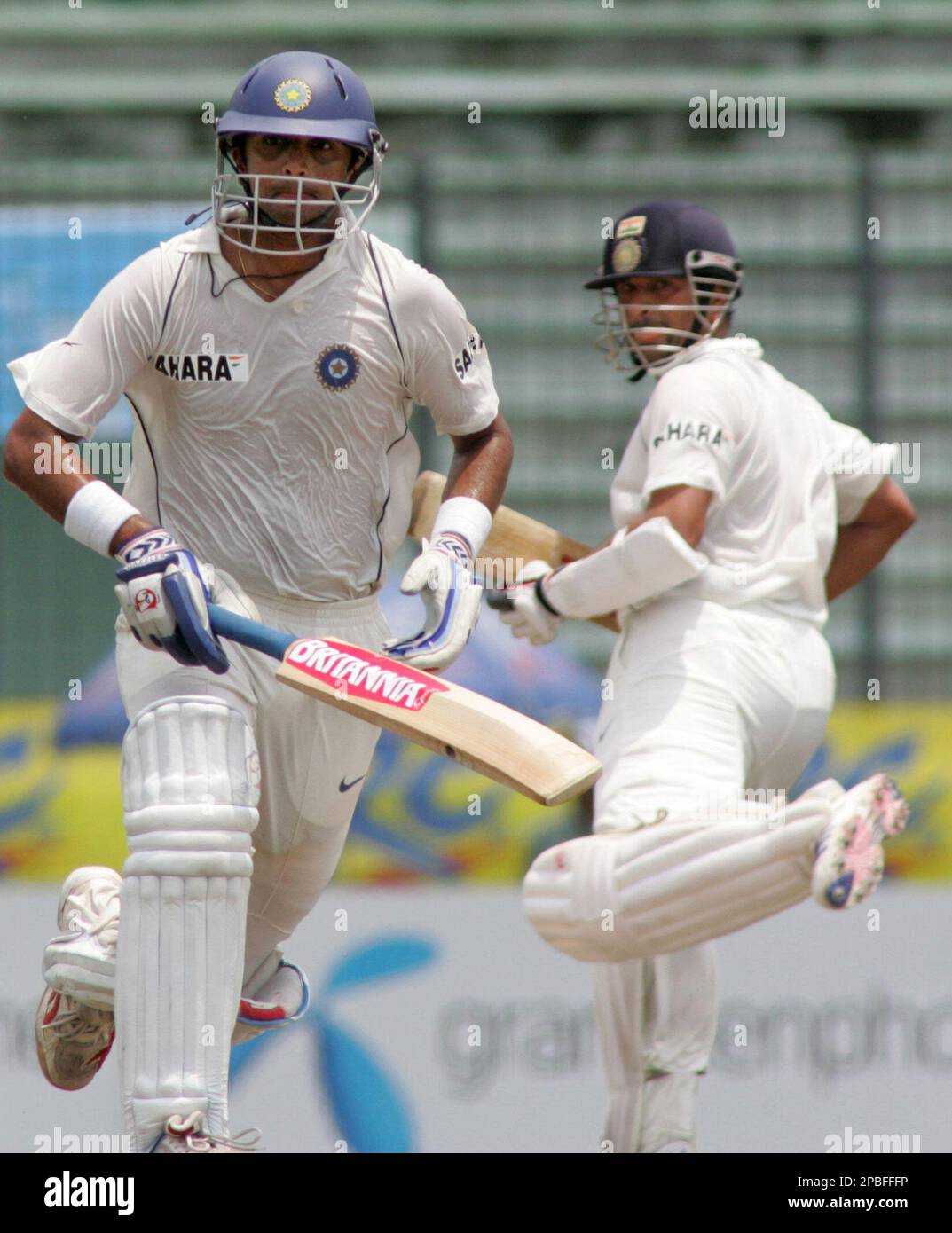 Indian cricketers Rahul Dravid, left, and Sachin Tendulkar run between ...