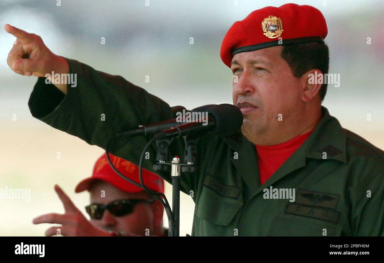 Venezuela's President Hugo Chavez points to a formation of Sukhoi Su-30 ...