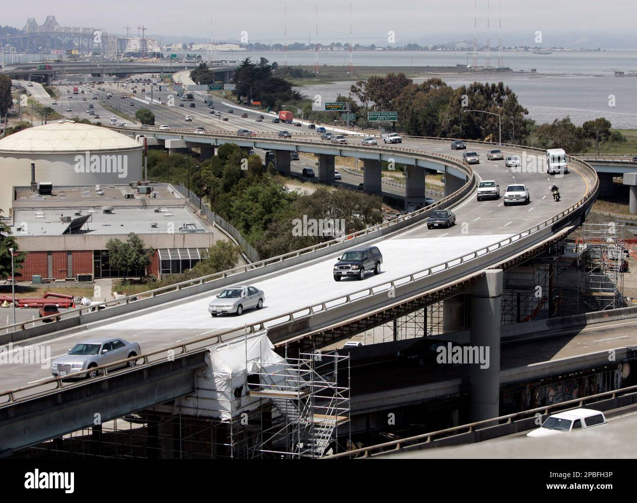Vehicles drive over the reopened freeway, shown in white, going ...