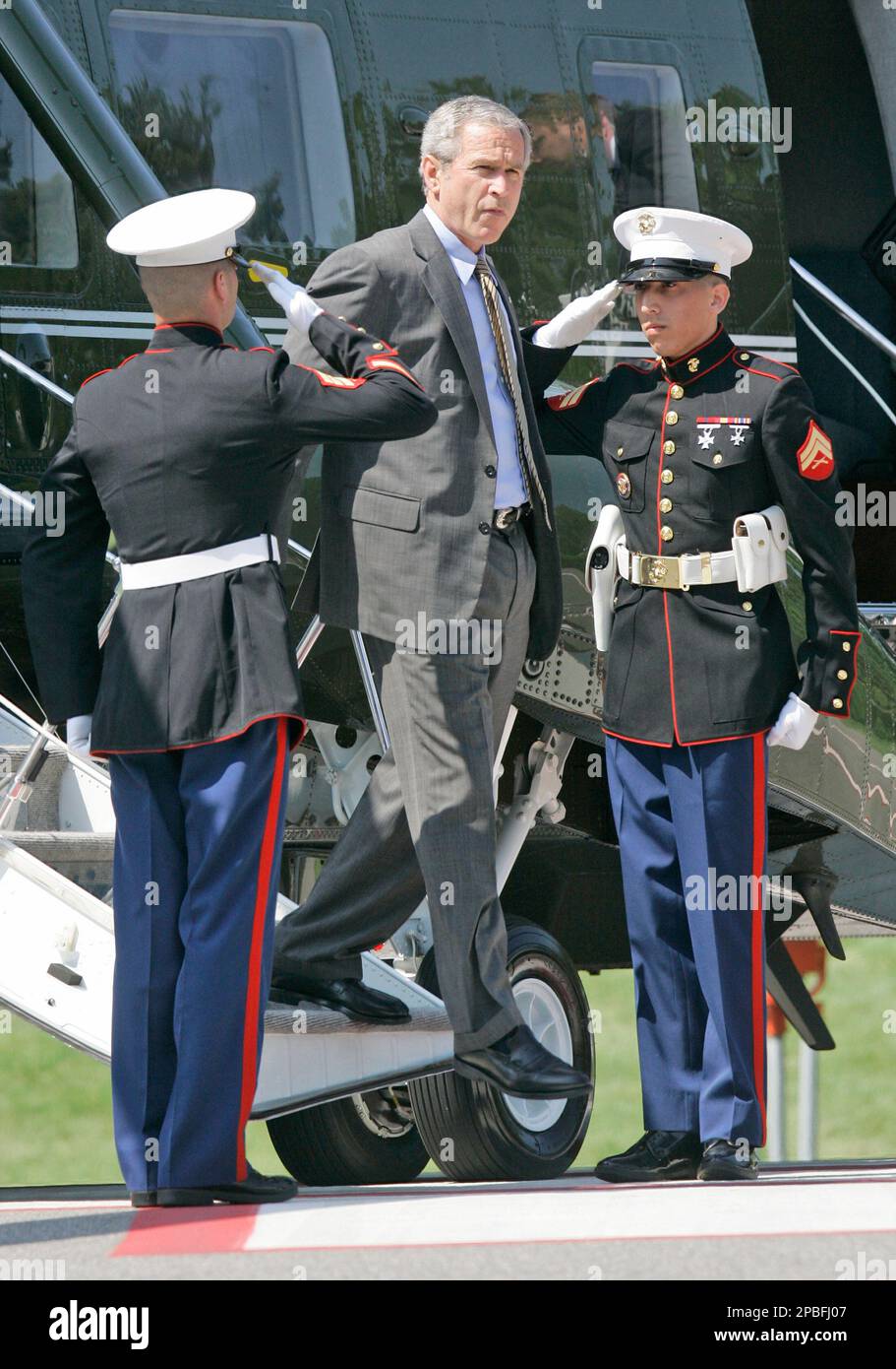 President Bush is saluted by Marines as he steps off Marine One ...