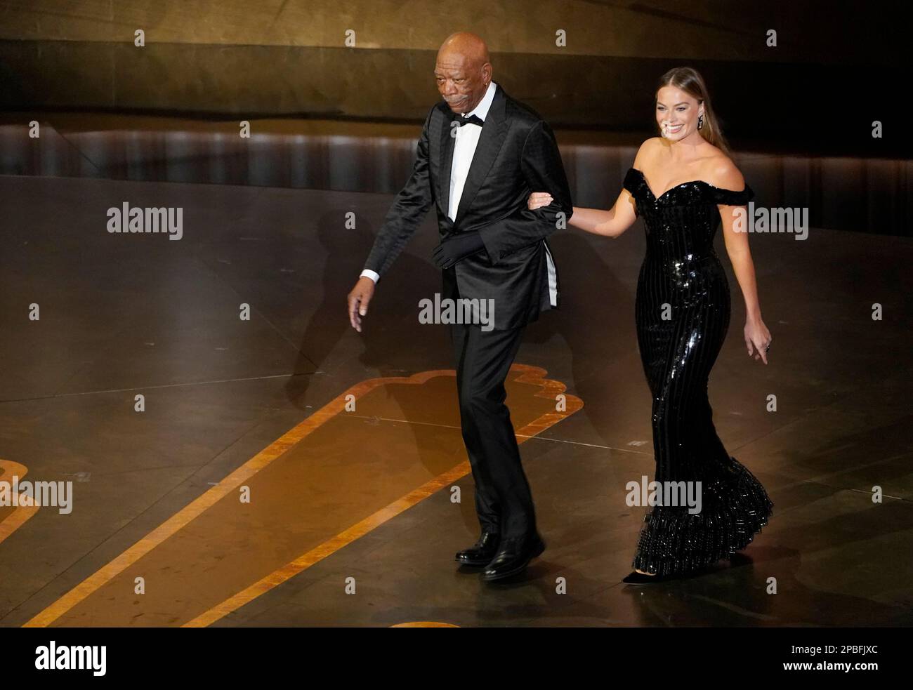Morgan Freeman, left, and Margot Robbie are seen walking onstage at the ...