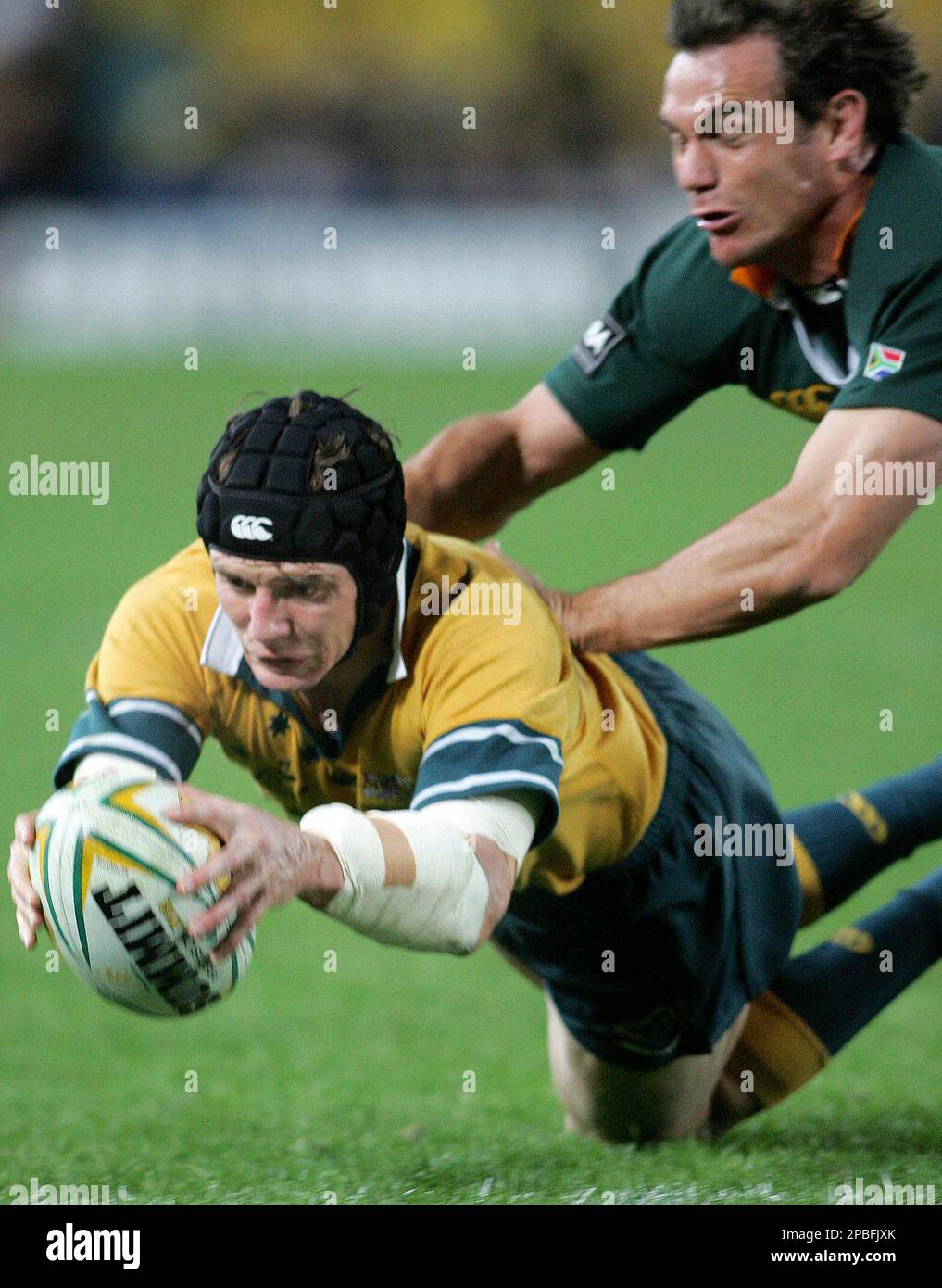 ** FILE ** Australia's Stephen Larkham stretches to score a try as an ...