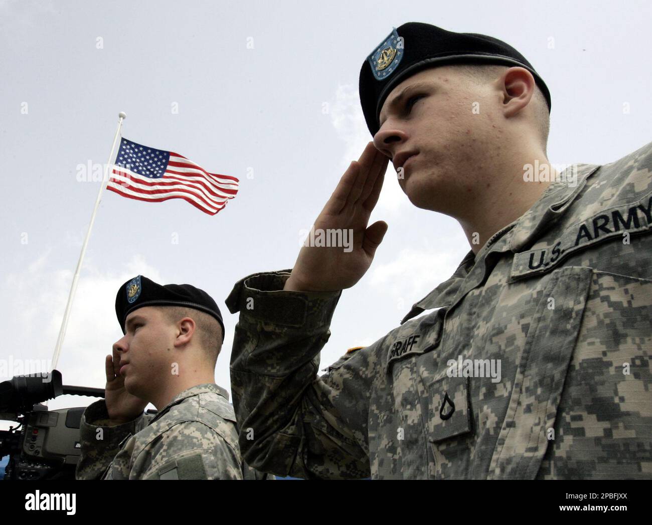 U.S. Army PFC. Justin Graff from Anchorage, Alaska, right, salutes ...