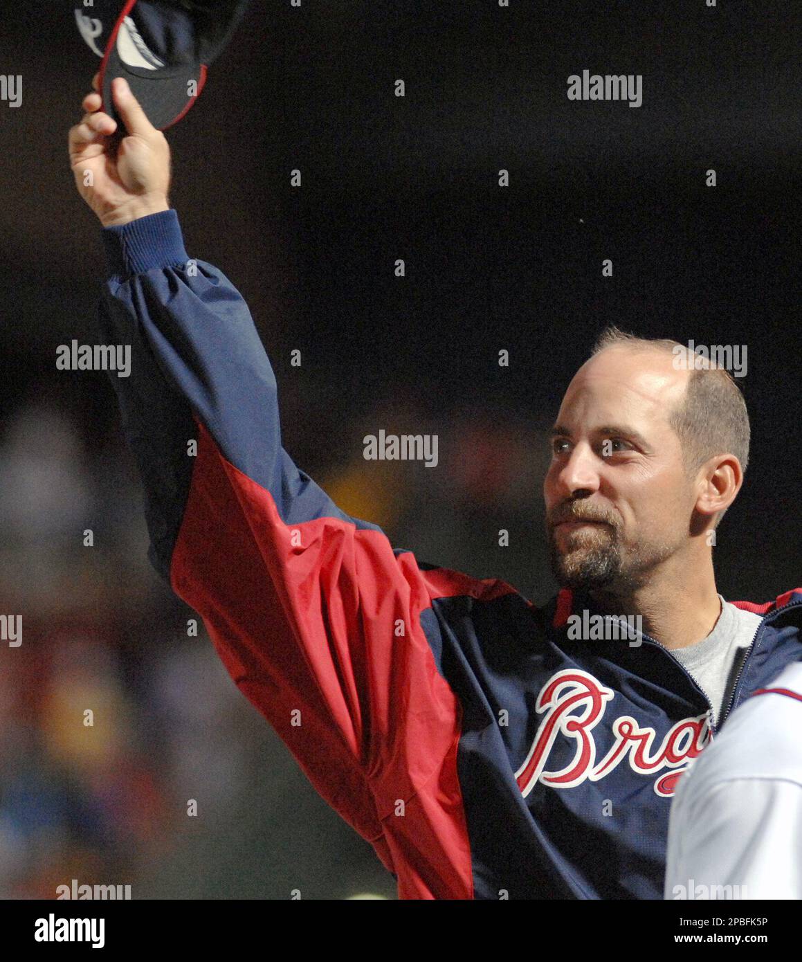 Atlanta Braves starter John Smoltz waves his cap to fans as he ...