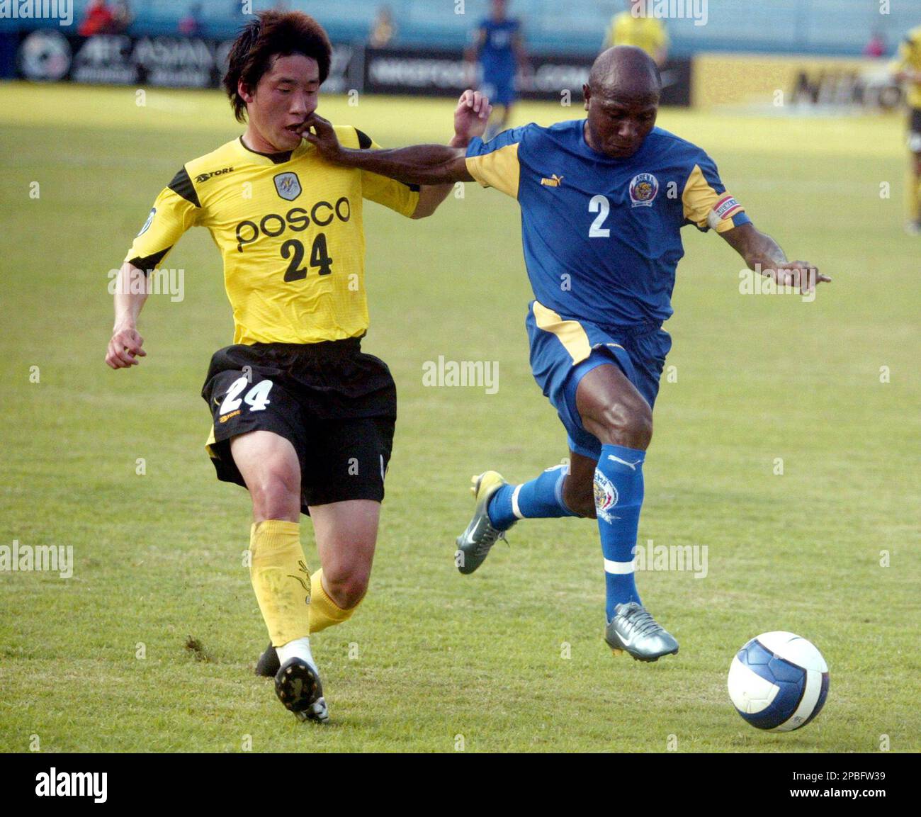 Chunham Dragon's Chang Dong-hyok, left, fights for the ball with Arema ...