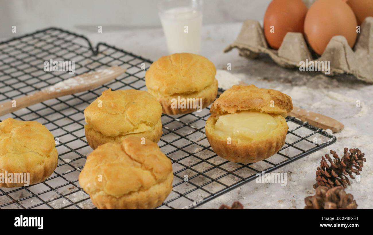 a traditional cake from Indonesia called kue sus filled with cream ...