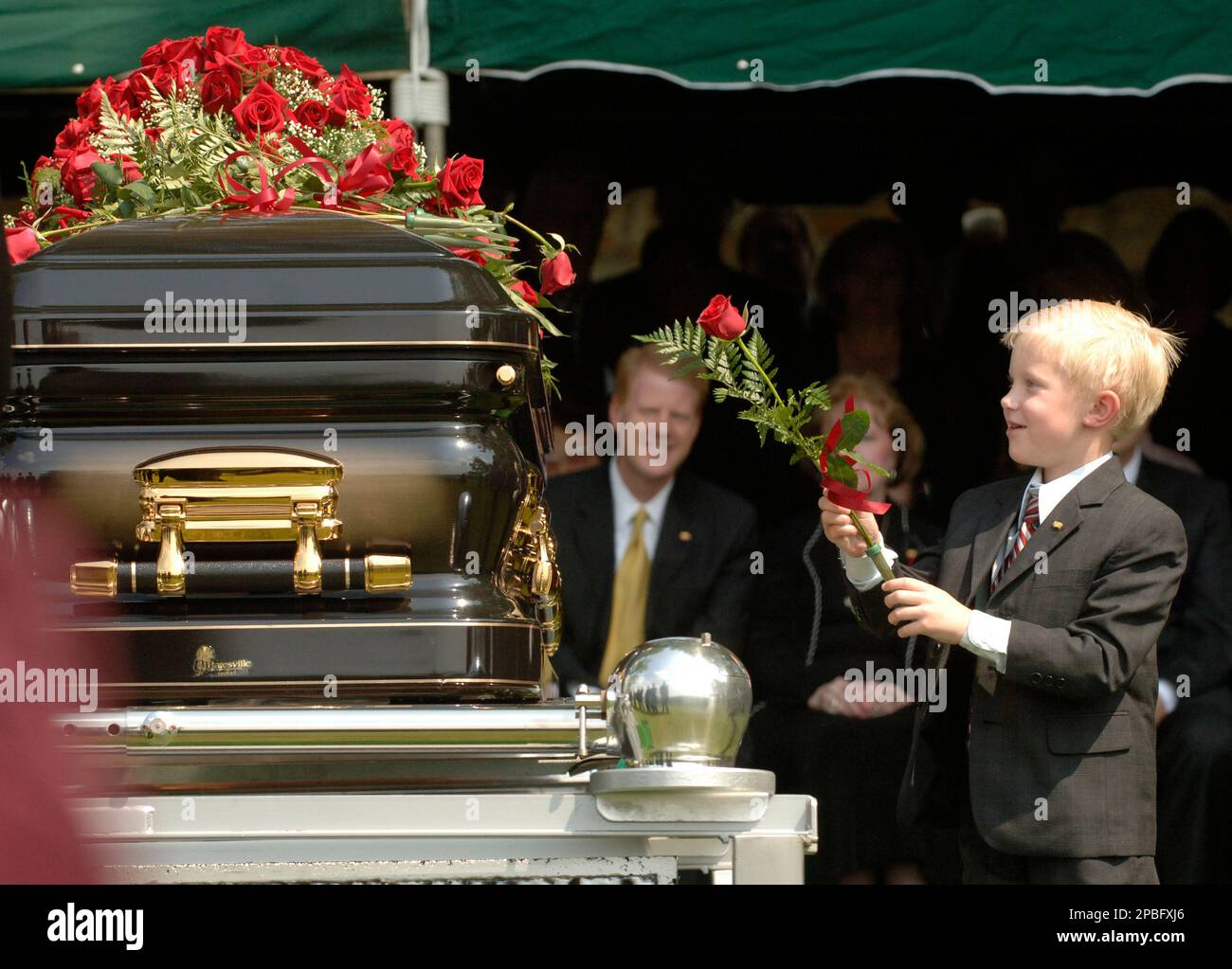 Nicholas Falwell, grandson of Rev. Jerry Falwell, places a rose on his ...