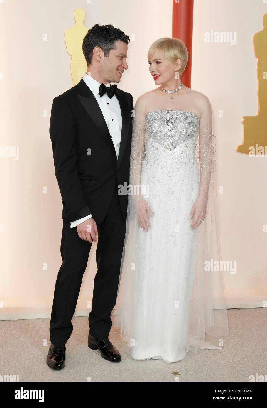 Thomas Kail, left and Michelle Williams arrive at the Oscars on Sunday ...