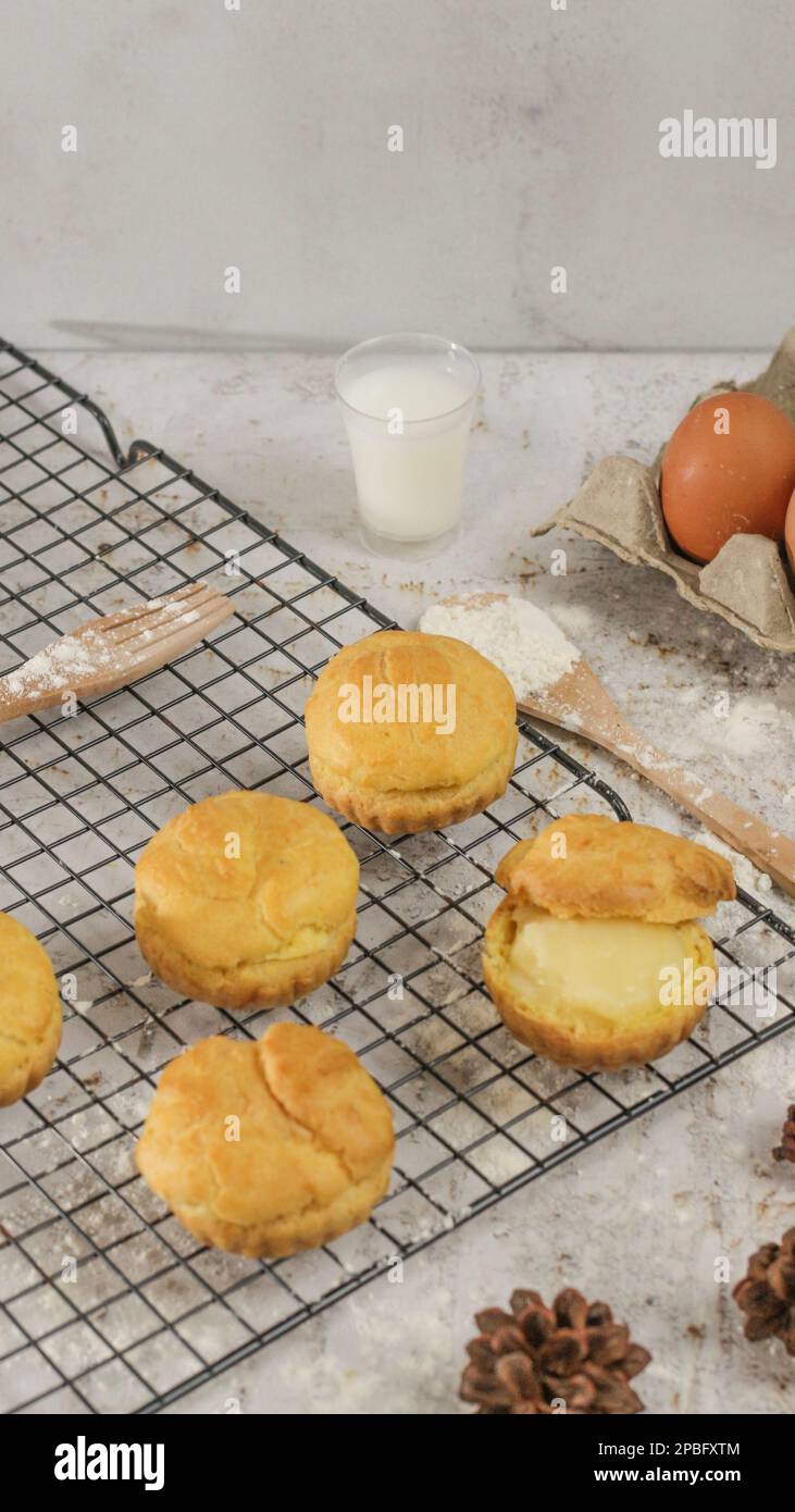 a traditional cake from Indonesia called kue sus filled with cream ...