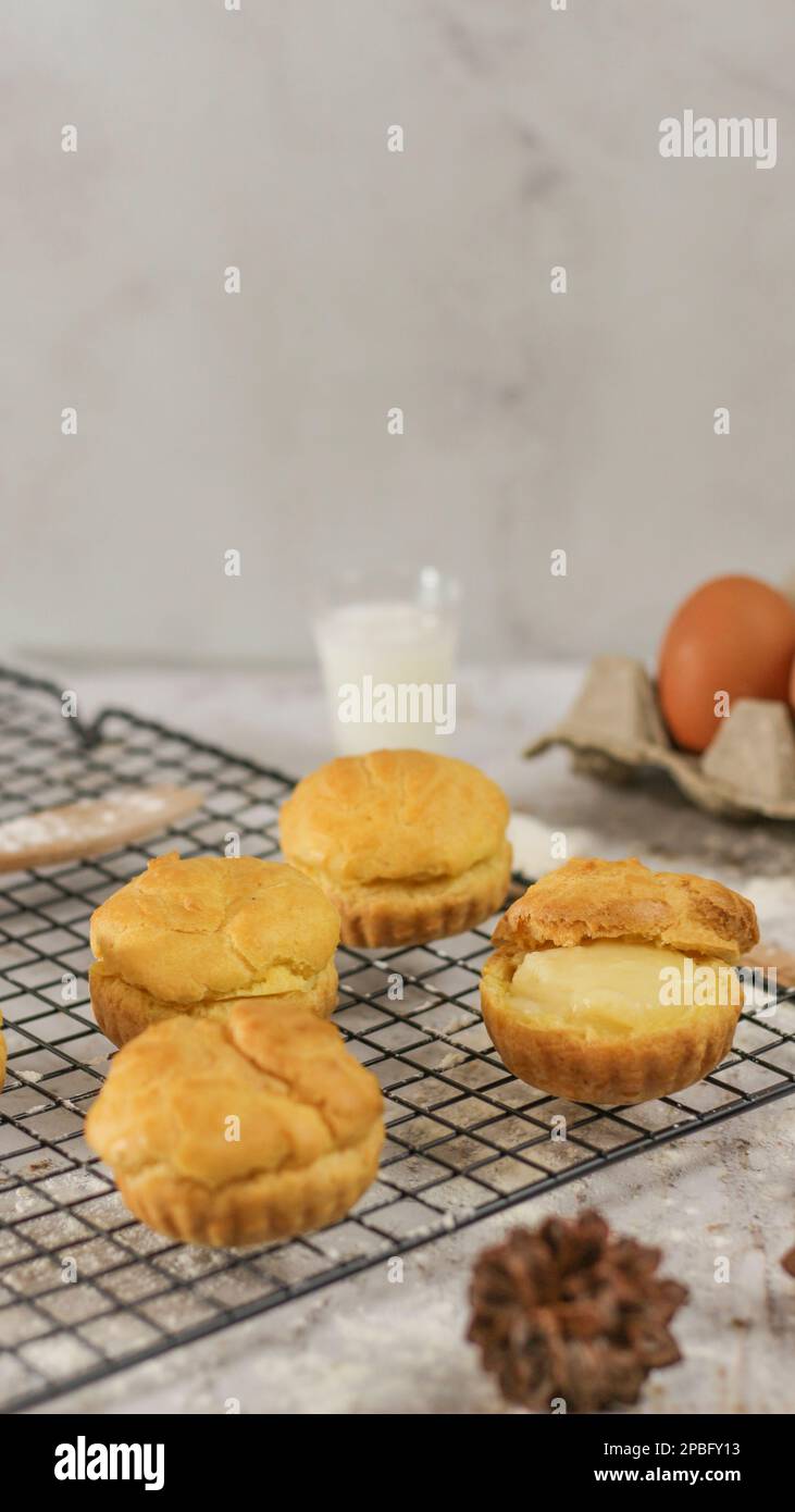 a traditional cake from Indonesia called kue sus filled with cream ...