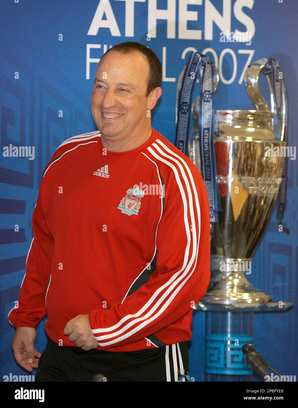 Liverpool soccer team coach Rafael Benitez smiles as his walks past the ...
