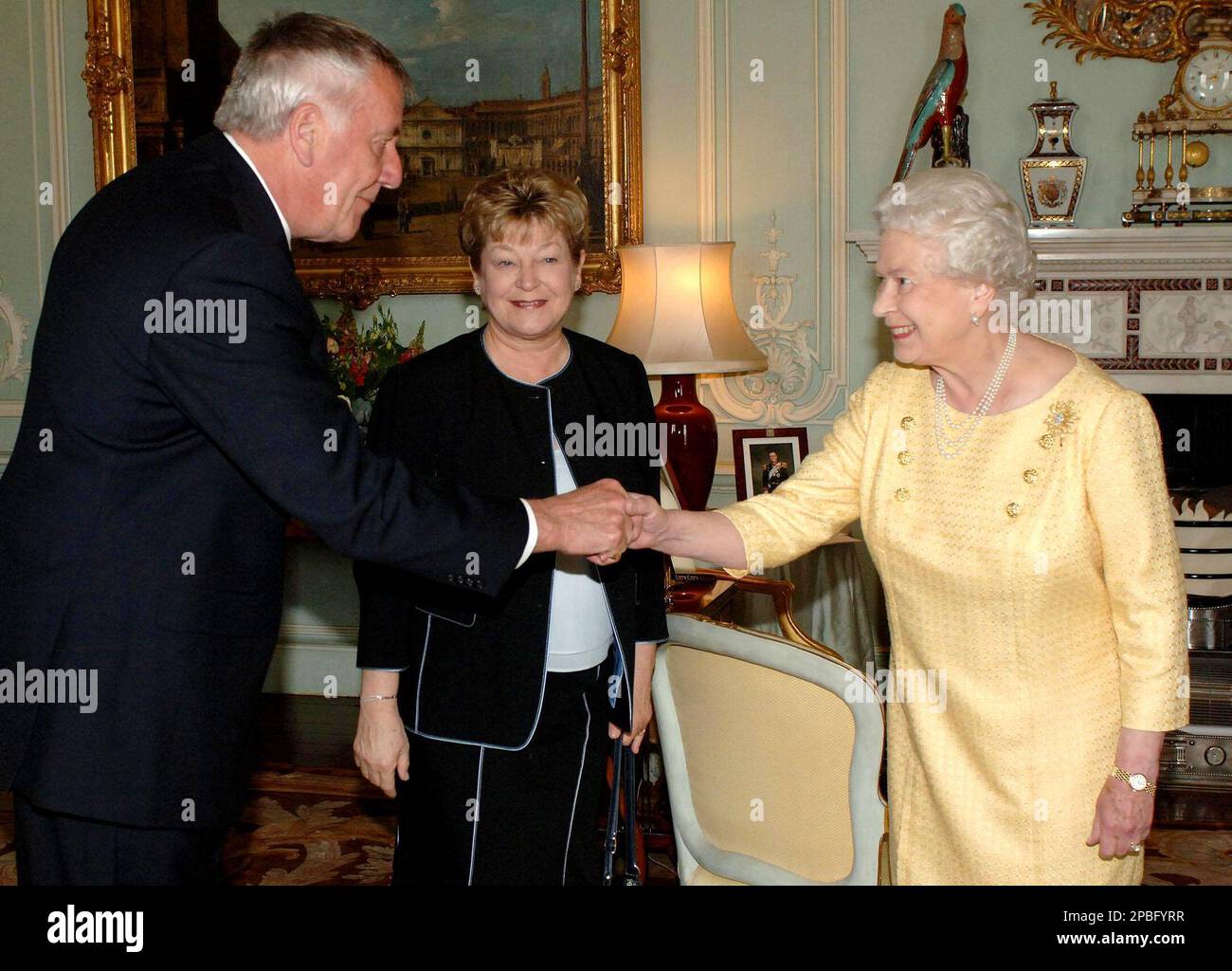 Britain's Queen Elizabeth II welcomes Nelson Hagerman, left, and his ...