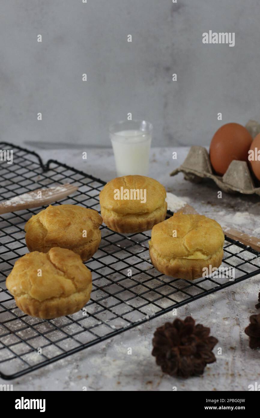 a traditional cake from Indonesia called kue sus filled with cream ...