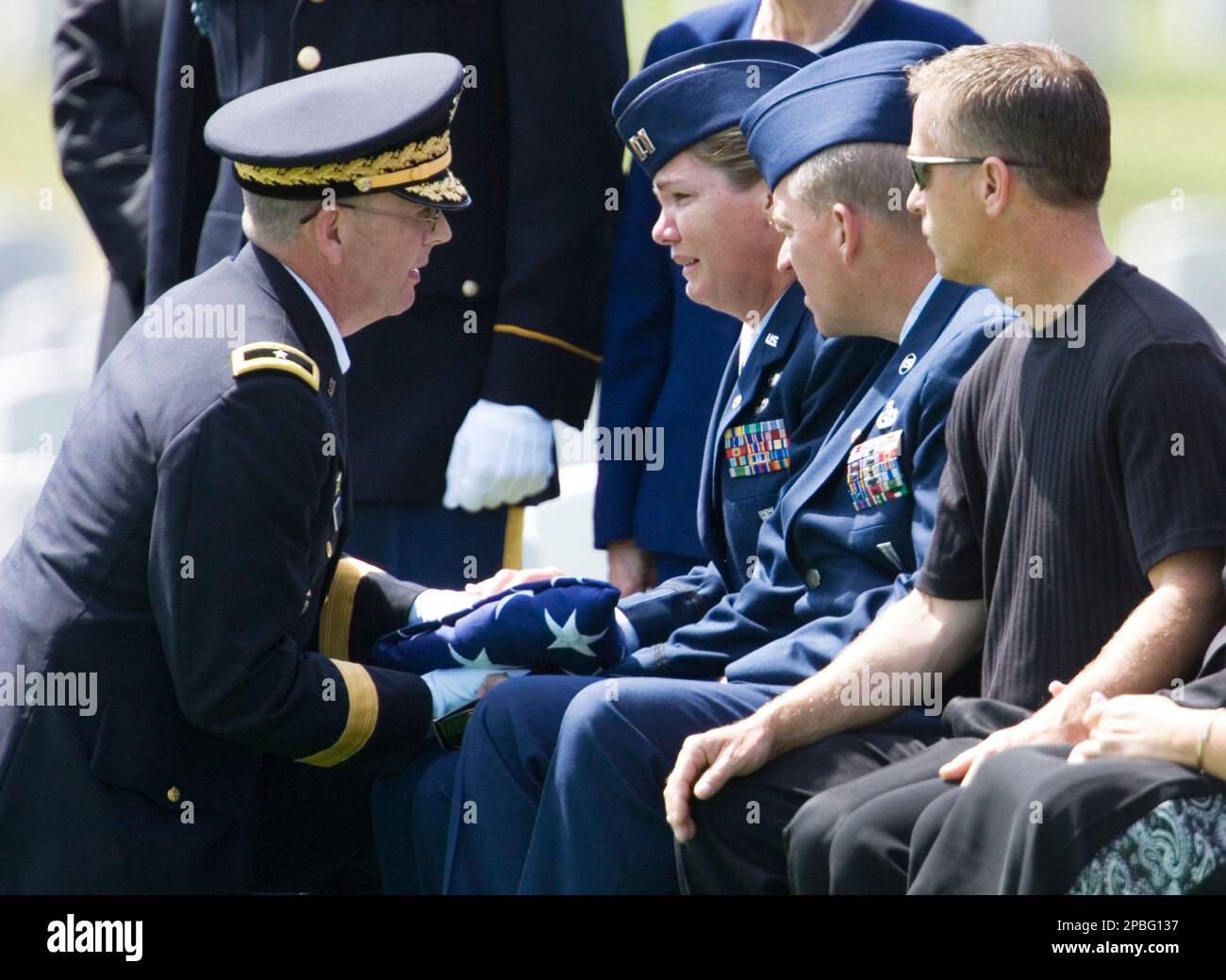 Army Brig. Gen. Keith McNamara, left, hands a flag that was placed over ...