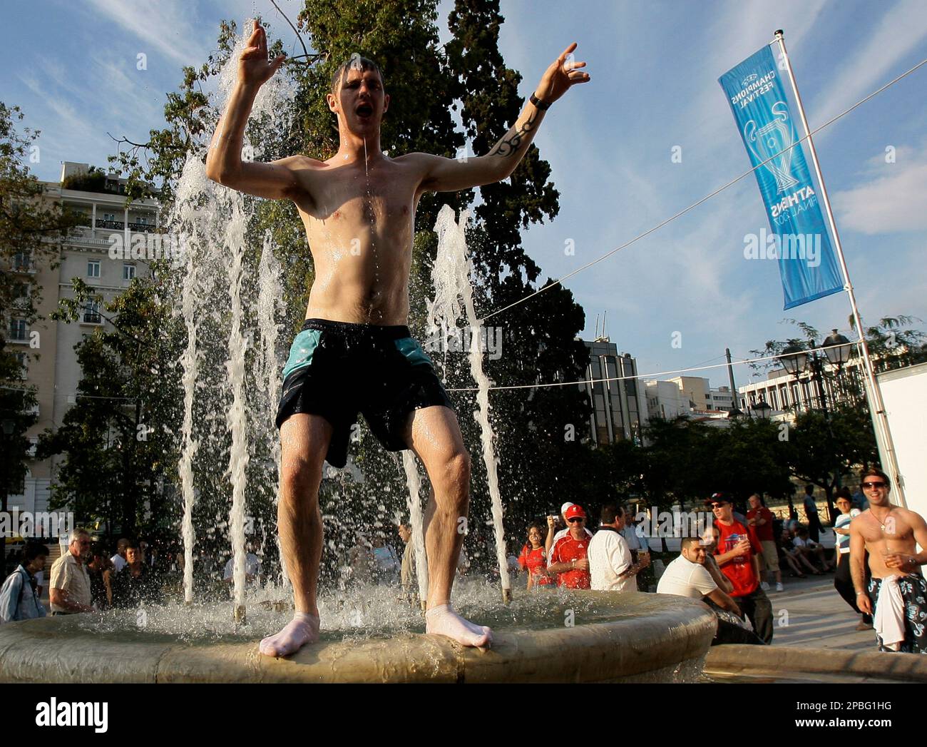 A Liverpool soccer fan plays in fountain in Athens main Syntagma Square ...