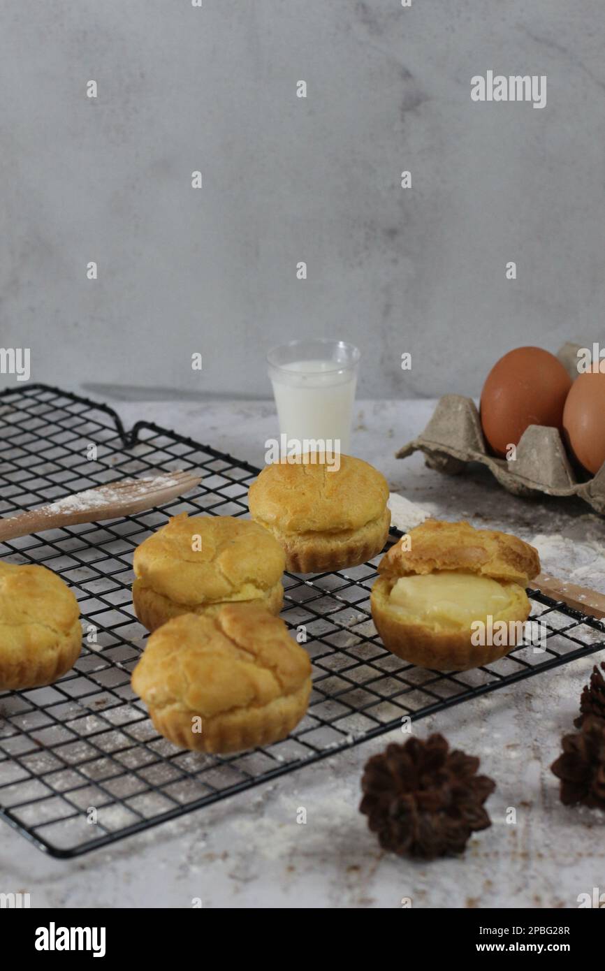 a traditional cake from Indonesia called kue sus filled with cream ...