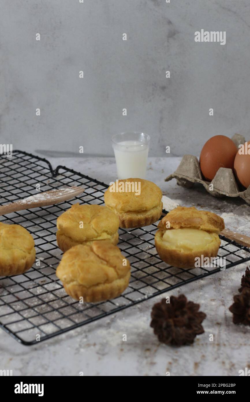 a traditional cake from Indonesia called kue sus filled with cream ...