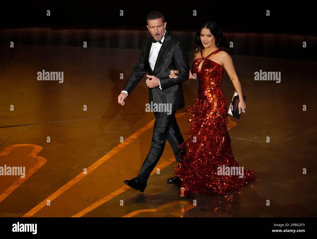 Antonio Banderas, left, and Salma Hayek walk onstage to present the ...