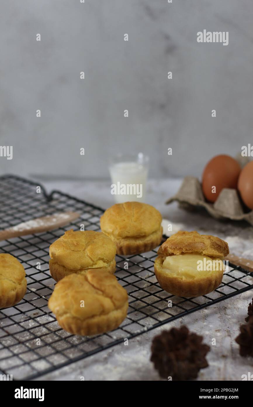 a traditional cake from Indonesia called kue sus filled with cream ...