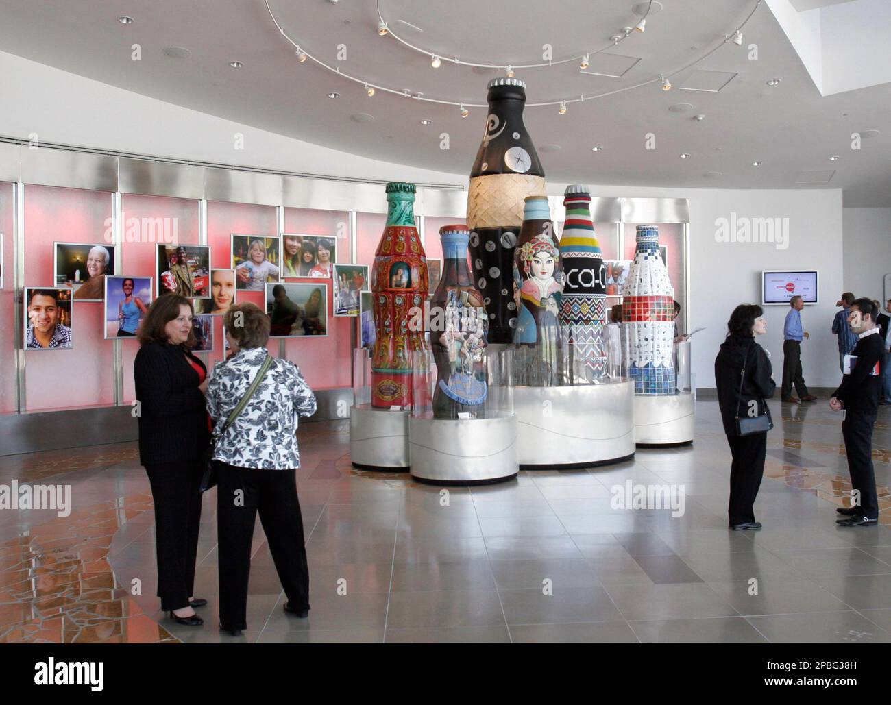 Preview guests check the entrance lobby area of the new World of Coca ...