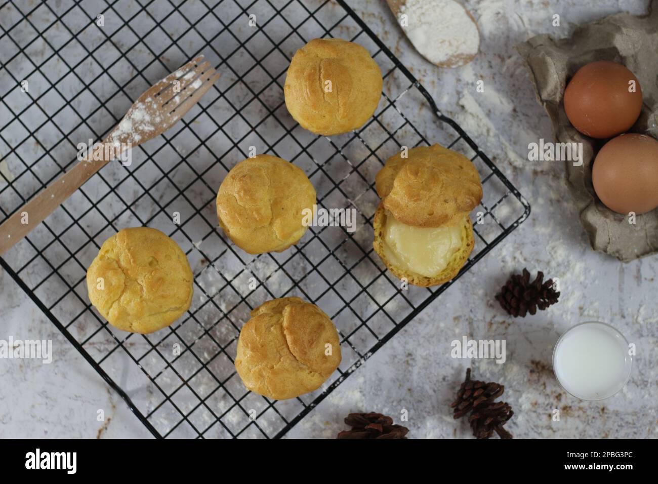 a traditional cake from Indonesia called kue sus filled with cream ...