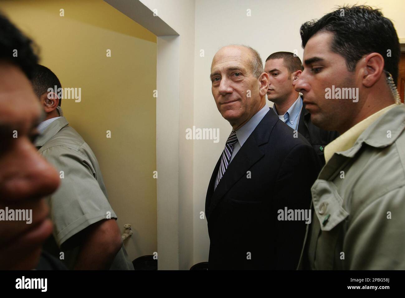 Israeli Prime Minister Ehud Olmert, center, surrounded by bodyguards ...