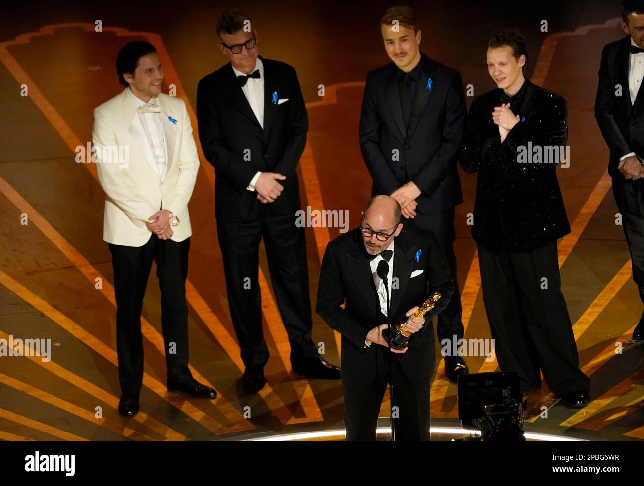 Edward Berger, forward center, accepts the award for "All Quiet on the ...