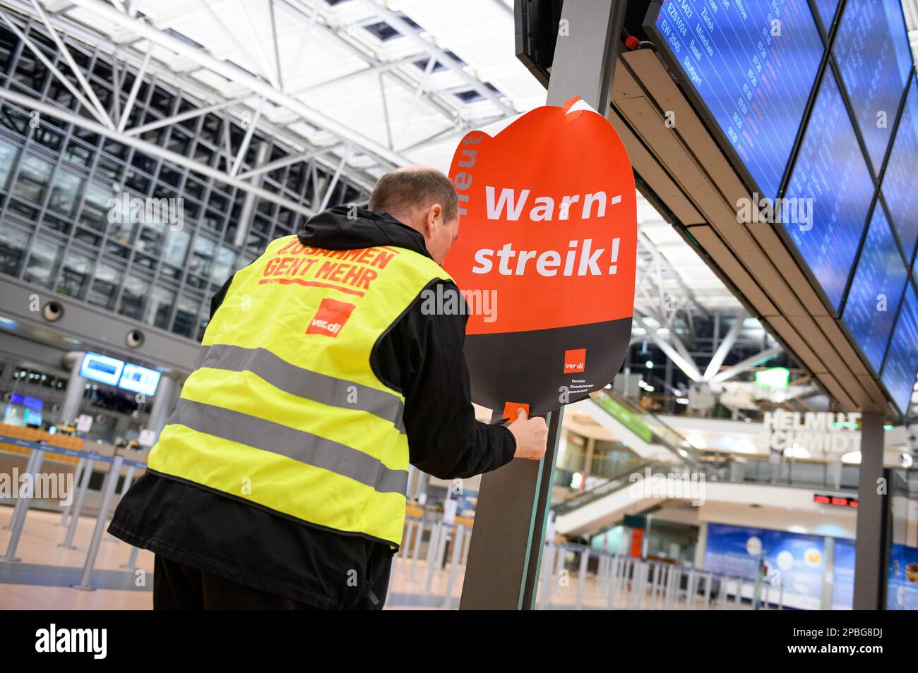 Hamburg, Germany. 12th Mar, 2023. A union representative sticks a ...