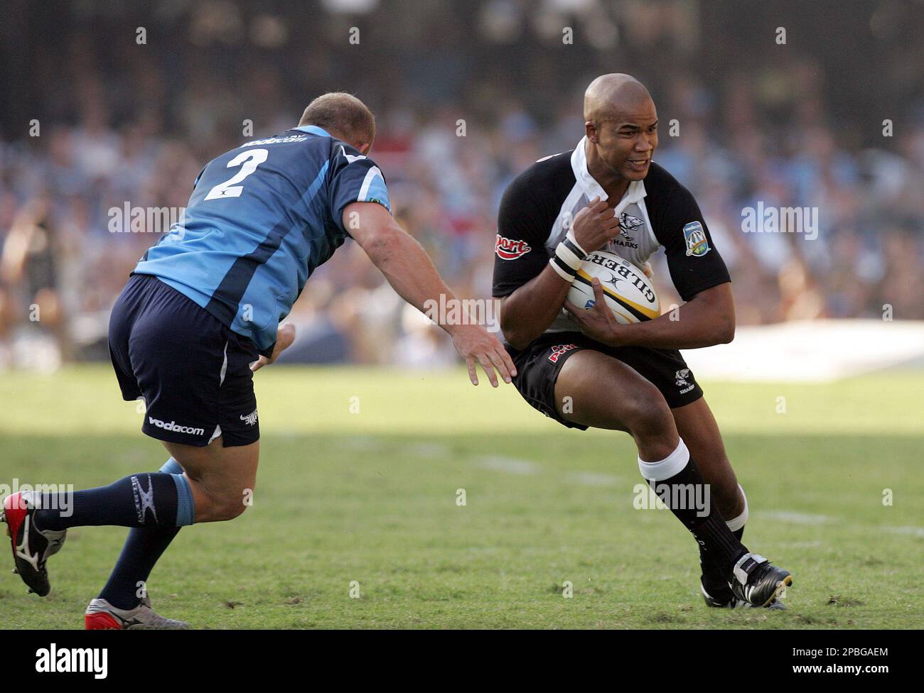 Sharks JP Pietersen, right, avoids a tackled from Bulls Gary Botha ...