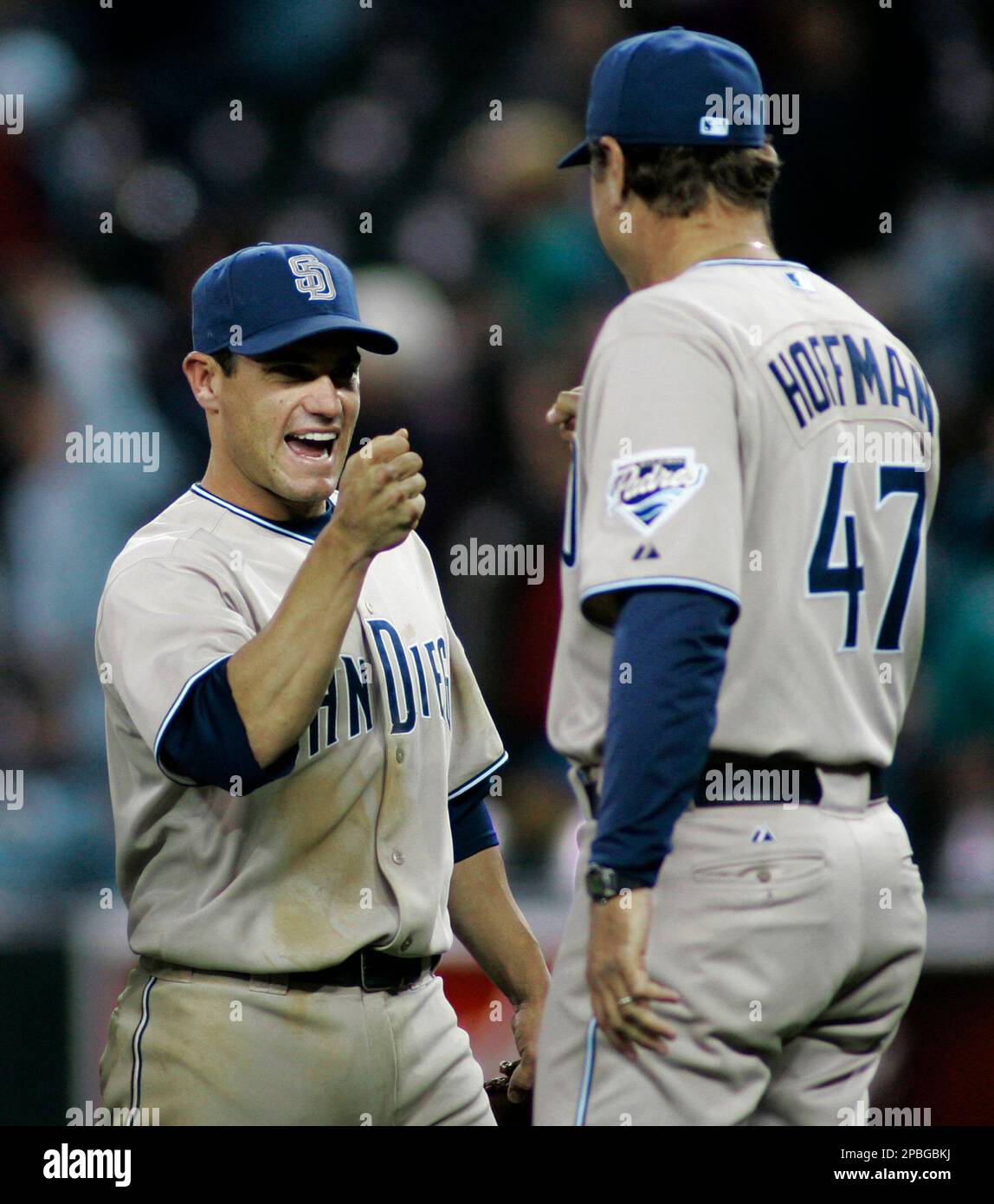 San Diego Padres' Marcus Giles, left, greets Padres third-base coach ...