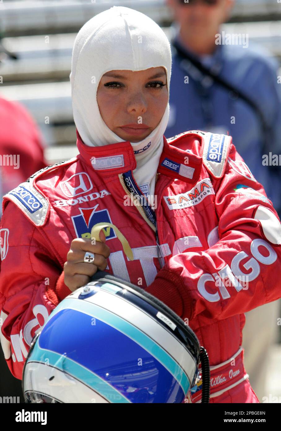 Race driver Milka Duno of Venezuela dons her helmet as she prepares to practice for the Indy 500 ...