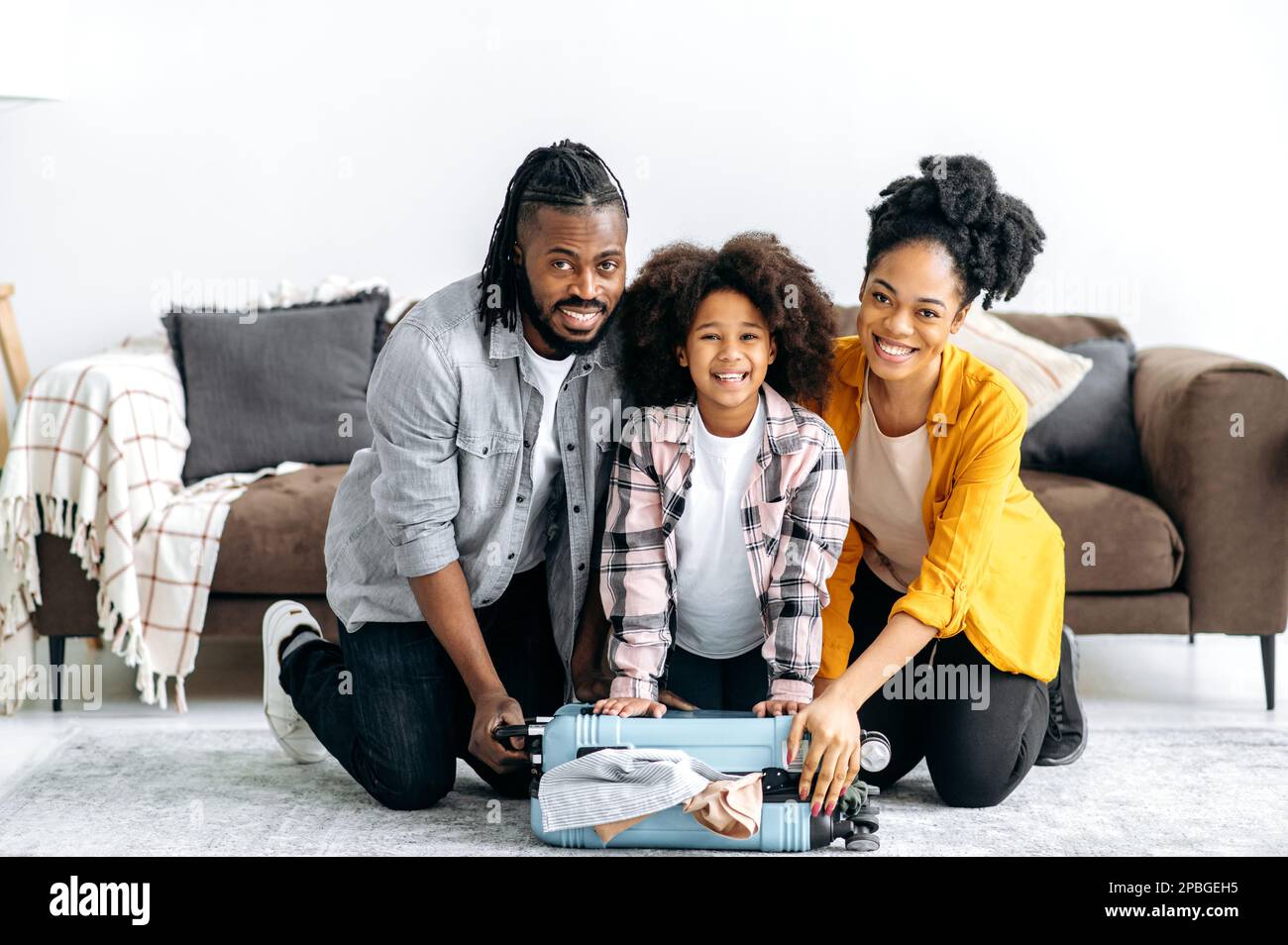 African woman packing suitcase hi-res stock photography and images - Alamy