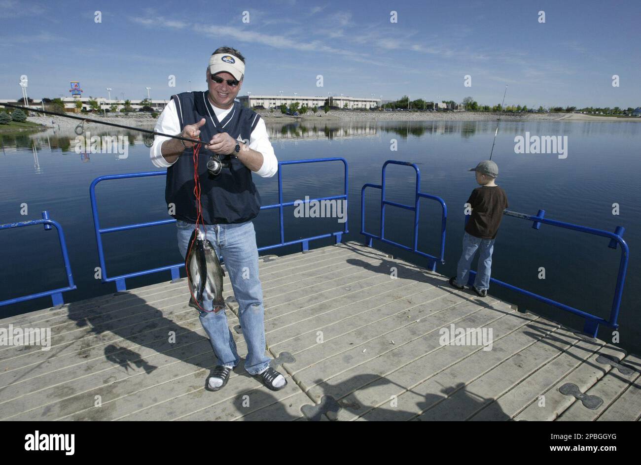 ** ADVANCE FOR SATURDAY May 19 ** Kyle Pinheiro, 7, right, fishes as ...
