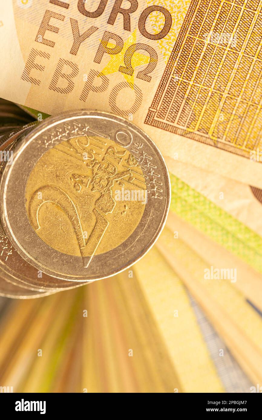Euro background. Bundle of euro banknotes and column of euro coins ...
