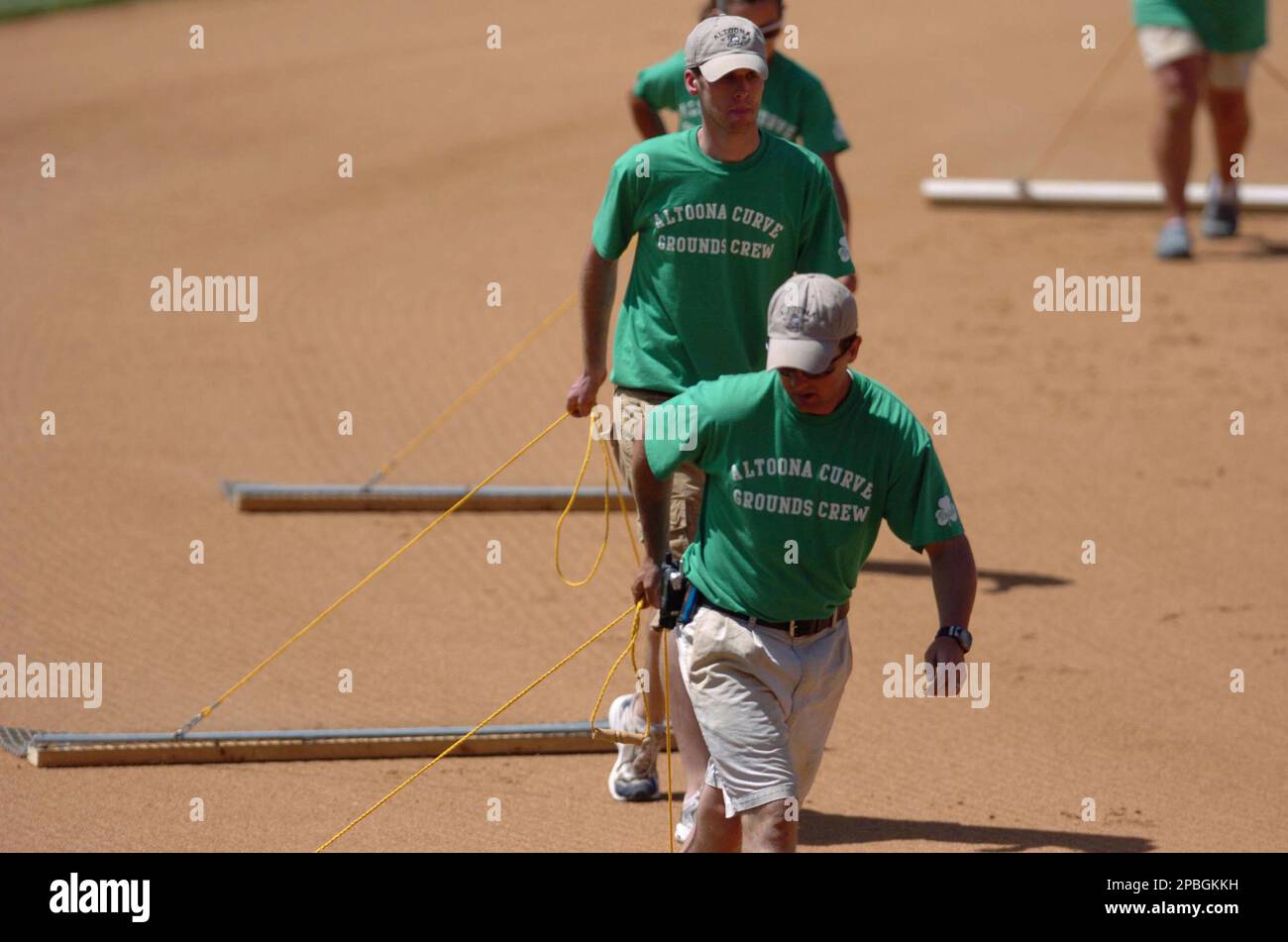Altoona Curve head groundskeeper Patrick Coakley, foreground, leads his ...