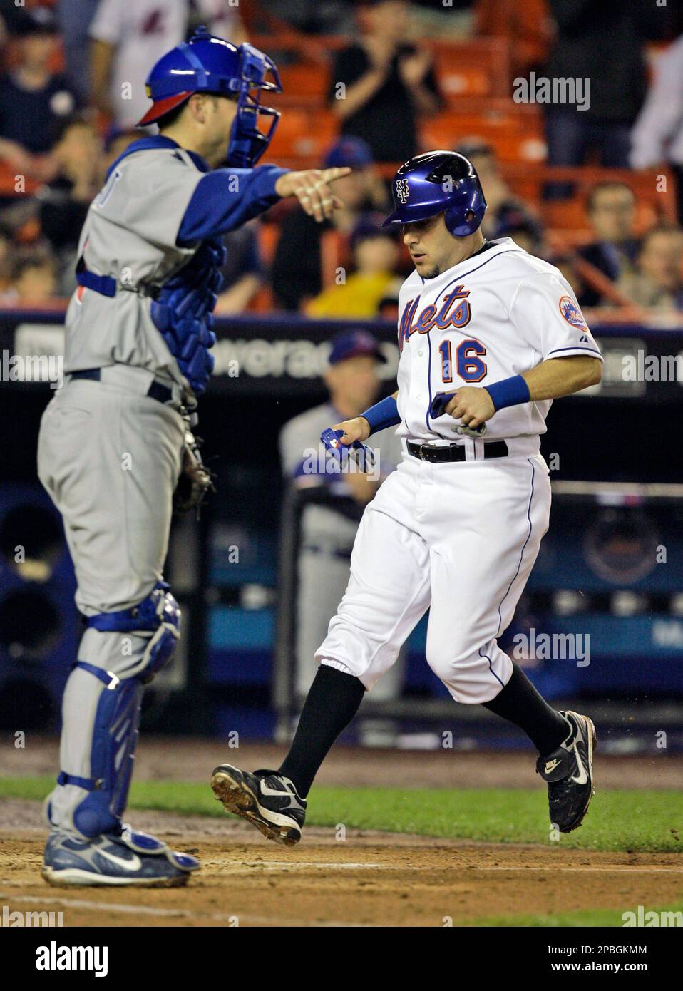 New York Mets' Paul Lo Duca scores, running past the gesturing Chicago ...