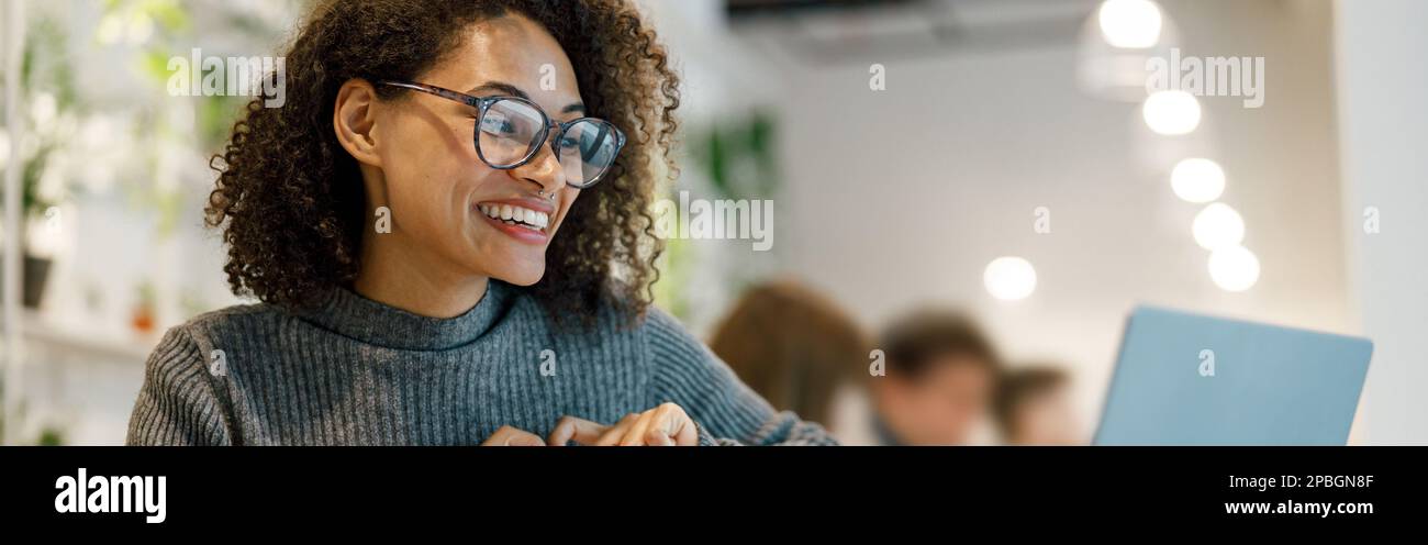 Smiling african woman speaks sign language with friends by video call ...