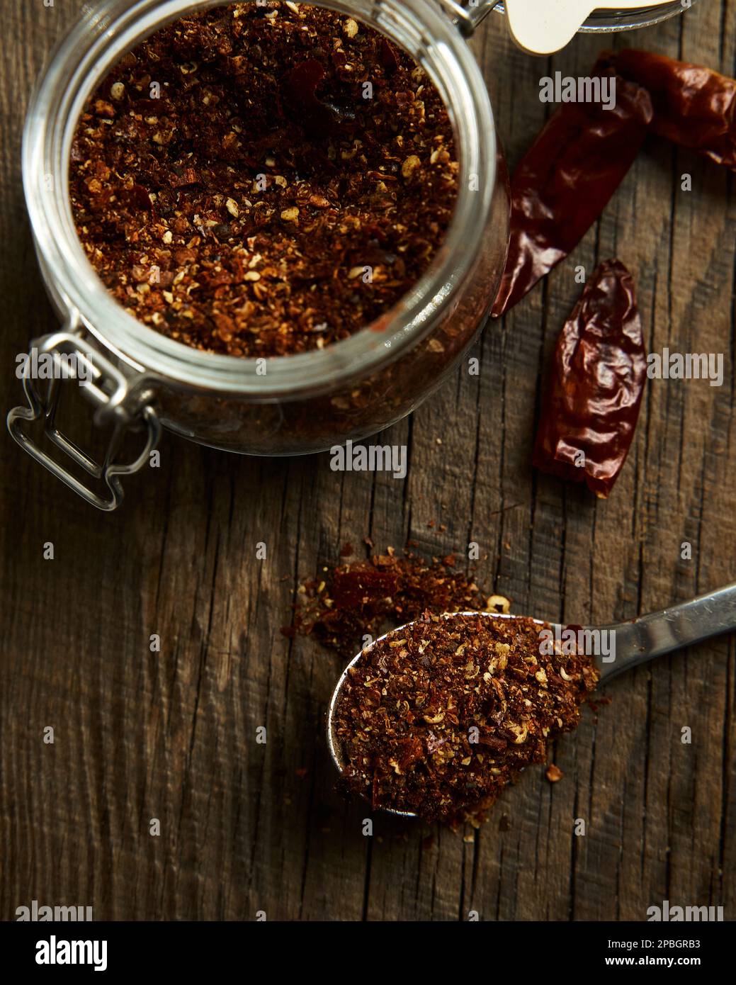 Roasted dry chili pepper powder in jar. Dried chilli on background. Top ...